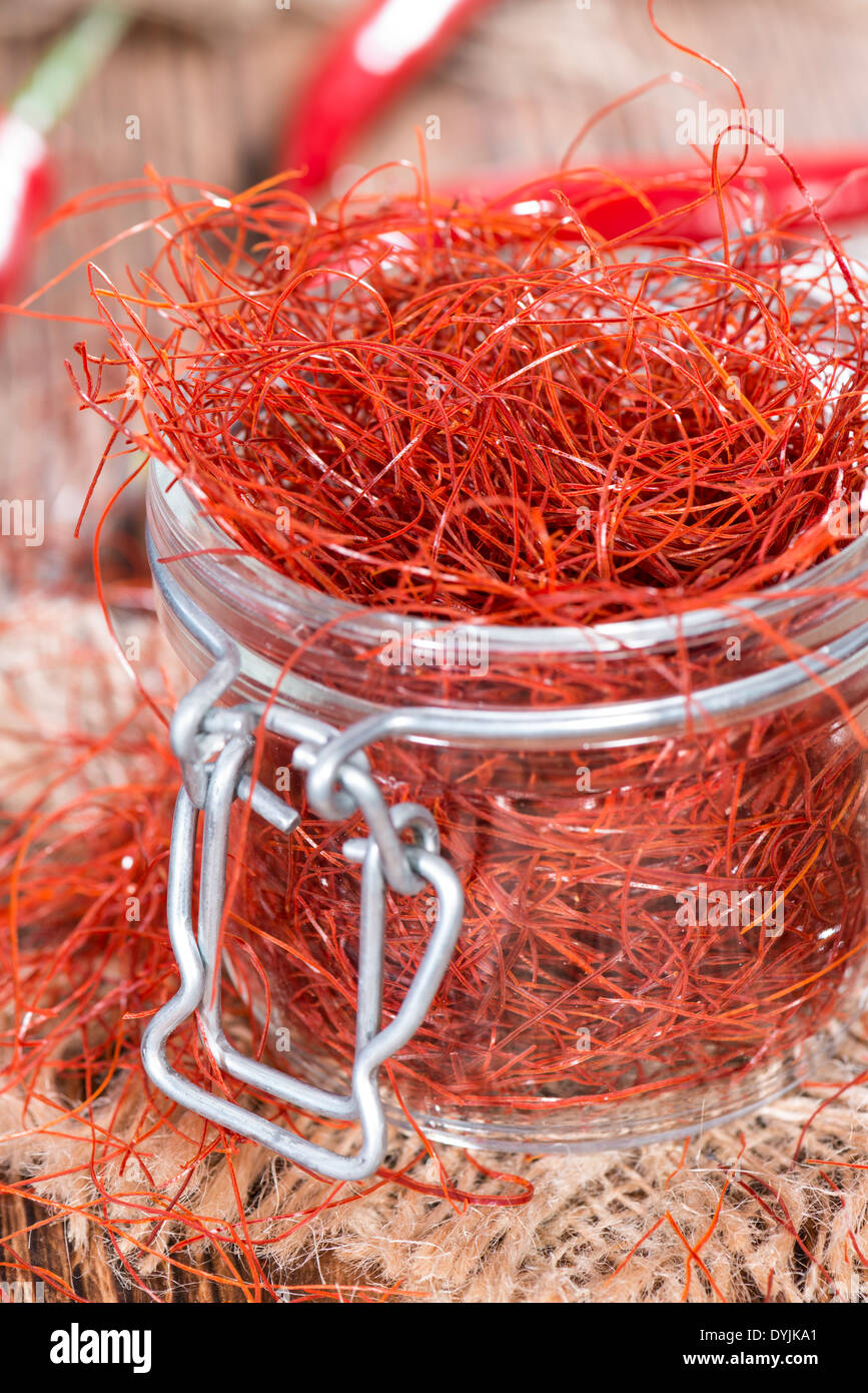 Small portion of dried Chilli Strings on wooden background Stock Photo ...