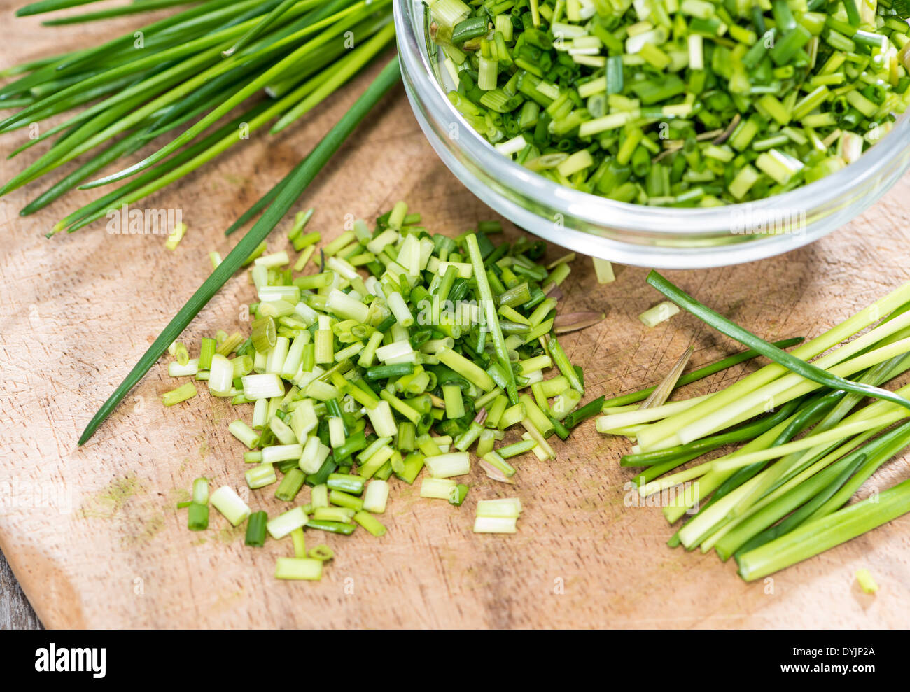 Small portion of fresh cutted Chive on vintage background Stock Photo ...