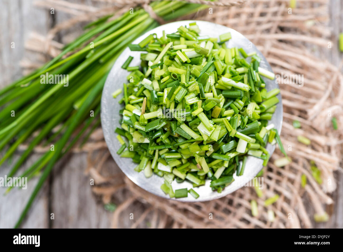 Small portion of fresh cutted Chive on vintage background Stock Photo ...