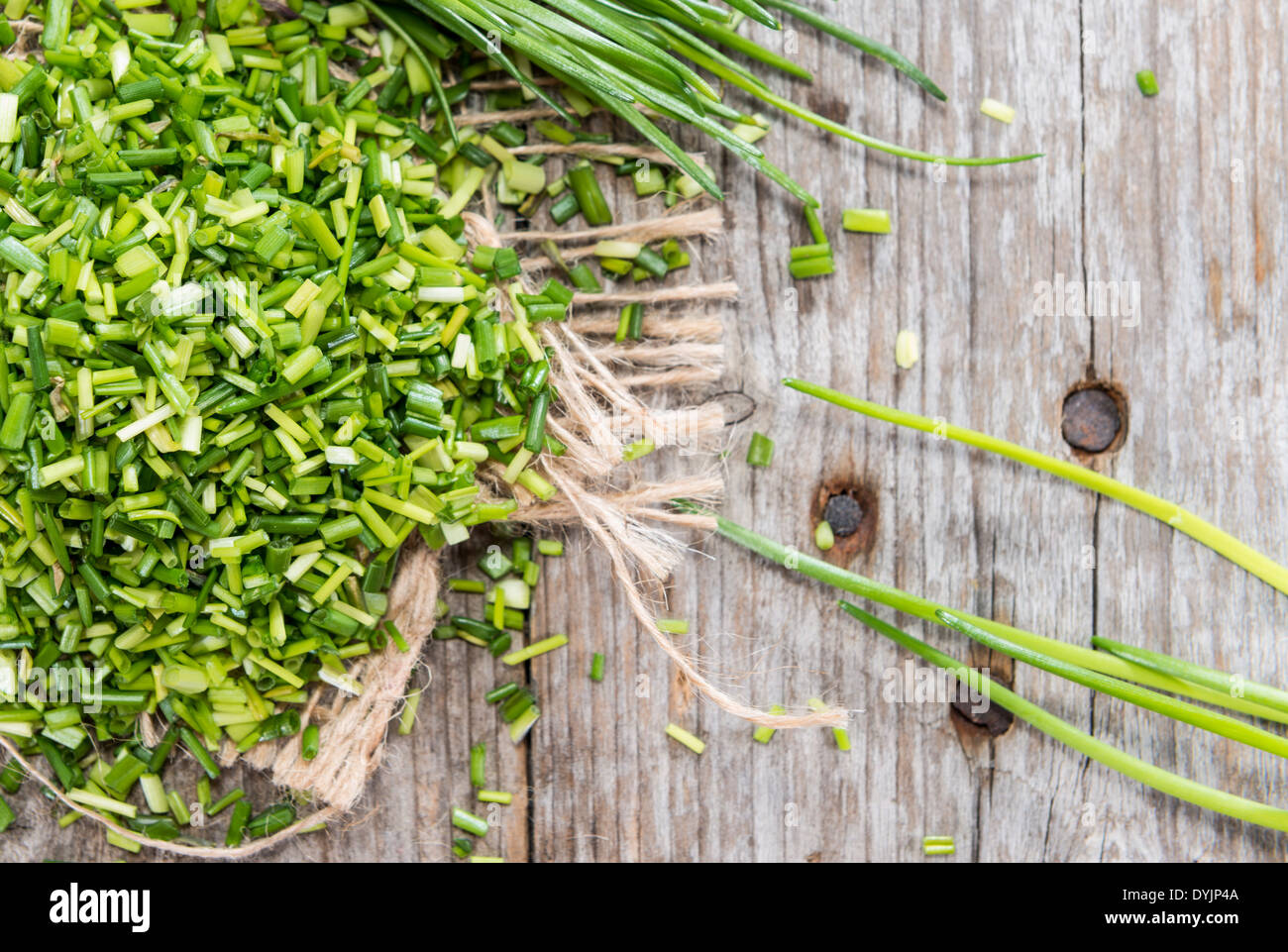 Small portion of fresh cutted Chive on vintage background Stock Photo ...