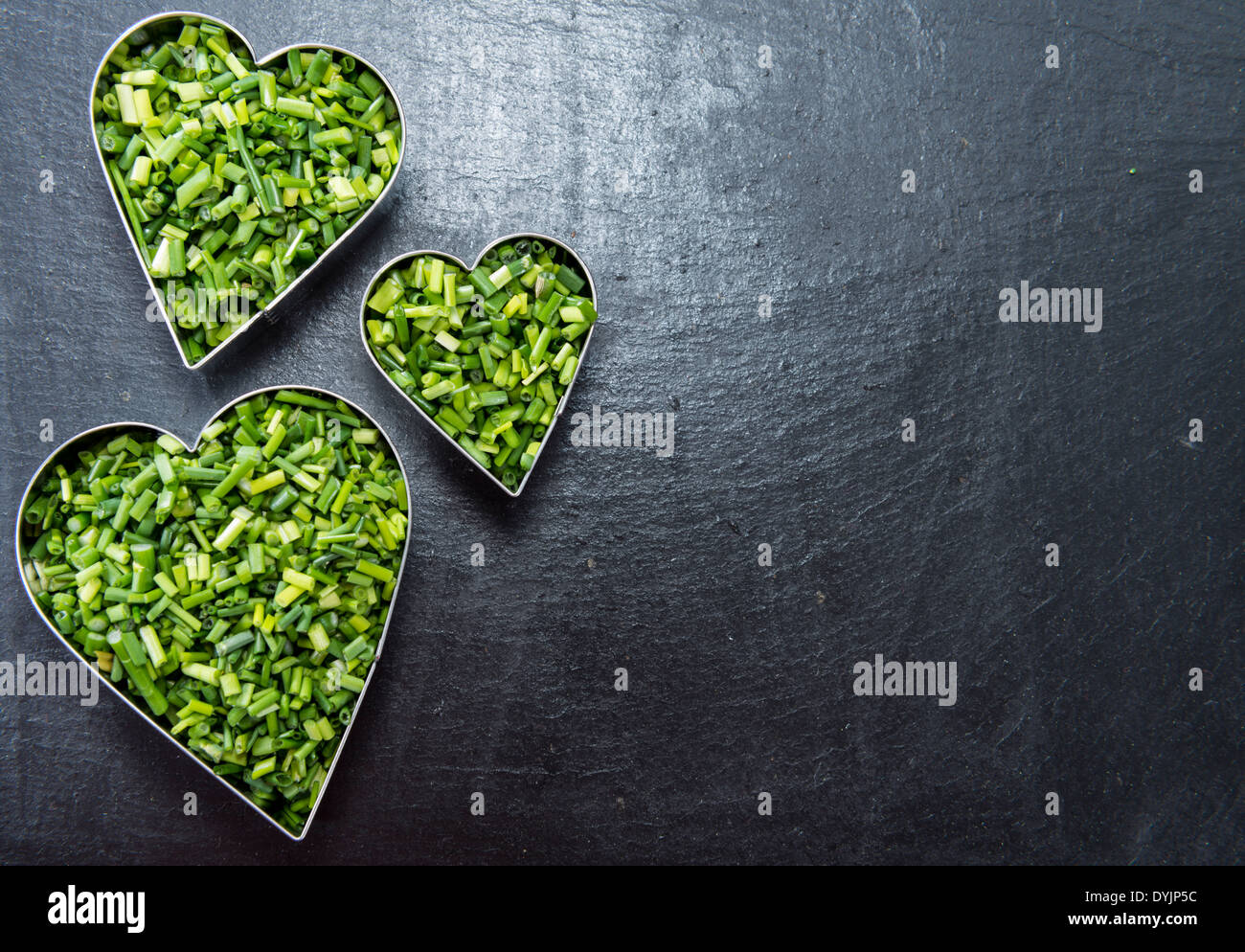 Heart shapes filled with fresh cutted Chive (I love herbs concept Stock ...