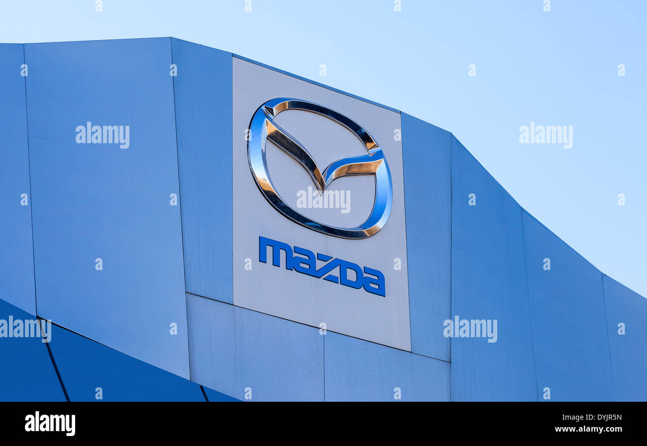 The emblem Mazda on blue sky background. Mazda Motor Corporation is a ...