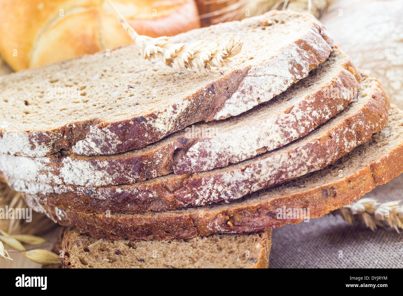 Loaf of bread sliced with crispy rolls Stock Photo - Alamy