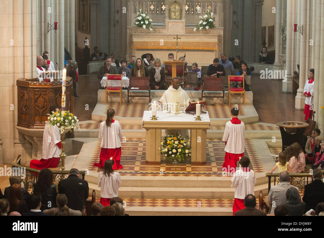 Wimbledon London, UK. 20th April 2014. A priest gives blessings as a ...
