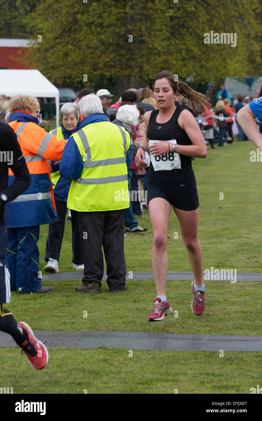 Female runner crossing finish line hi-res stock photography and images ...