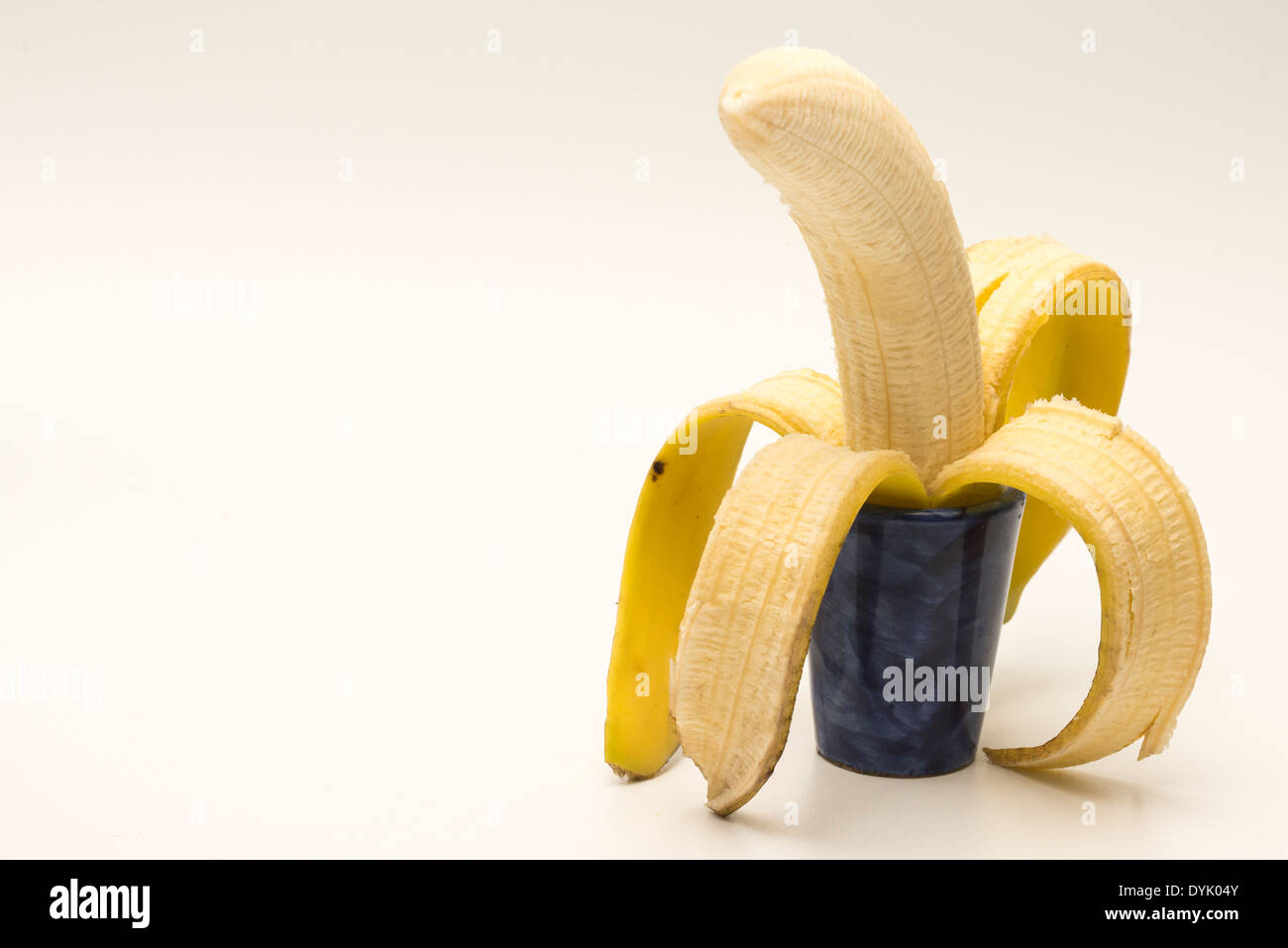 Single open banana in small pot isolated on white background Stock ...