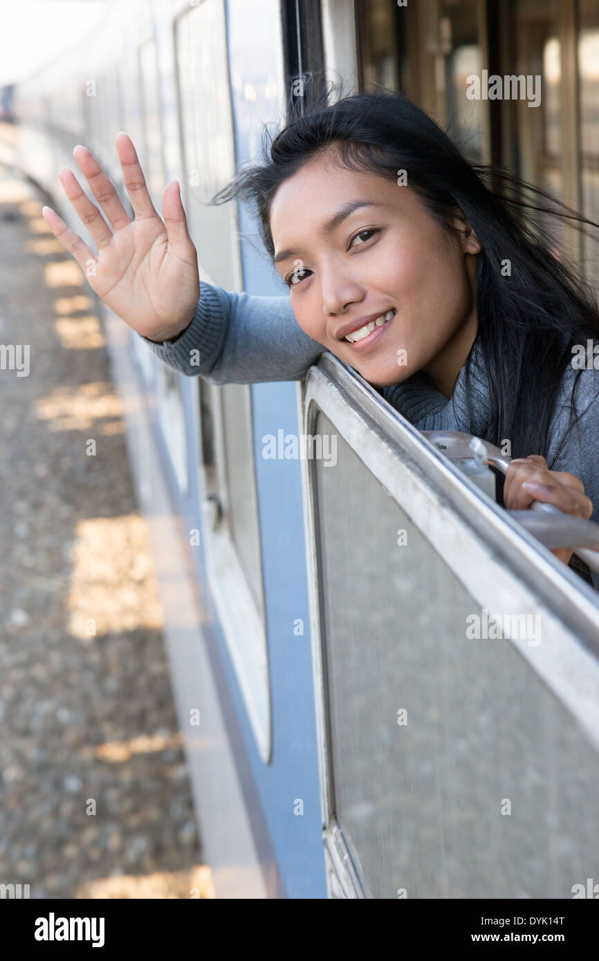 woman waving a greeting from moving train Stock Photo - Alamy