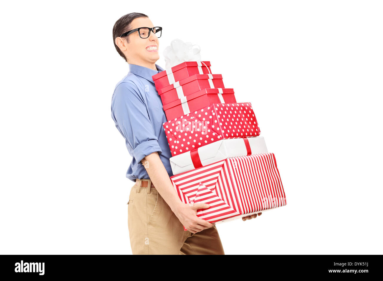 Man carrying a heavy load of gifts Stock Photo - Alamy