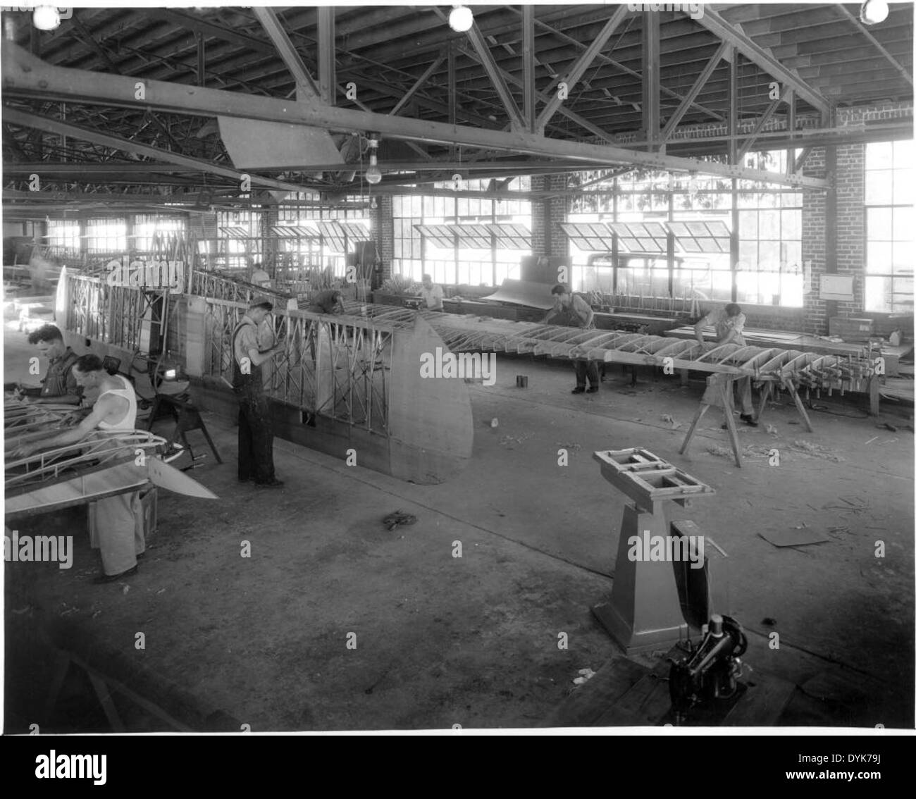 This image shows Mort Brown, a test pilot, inspecting the wings of an ...