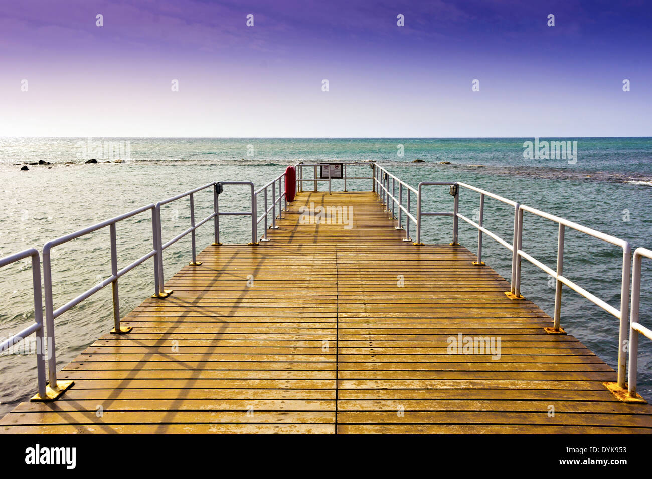 Wooden jetty with metal railings Stock Photo - Alamy