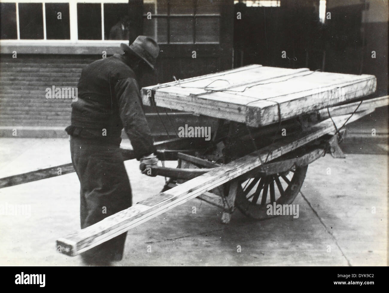 Worker with Wheelbarrow Stock Photo - Alamy