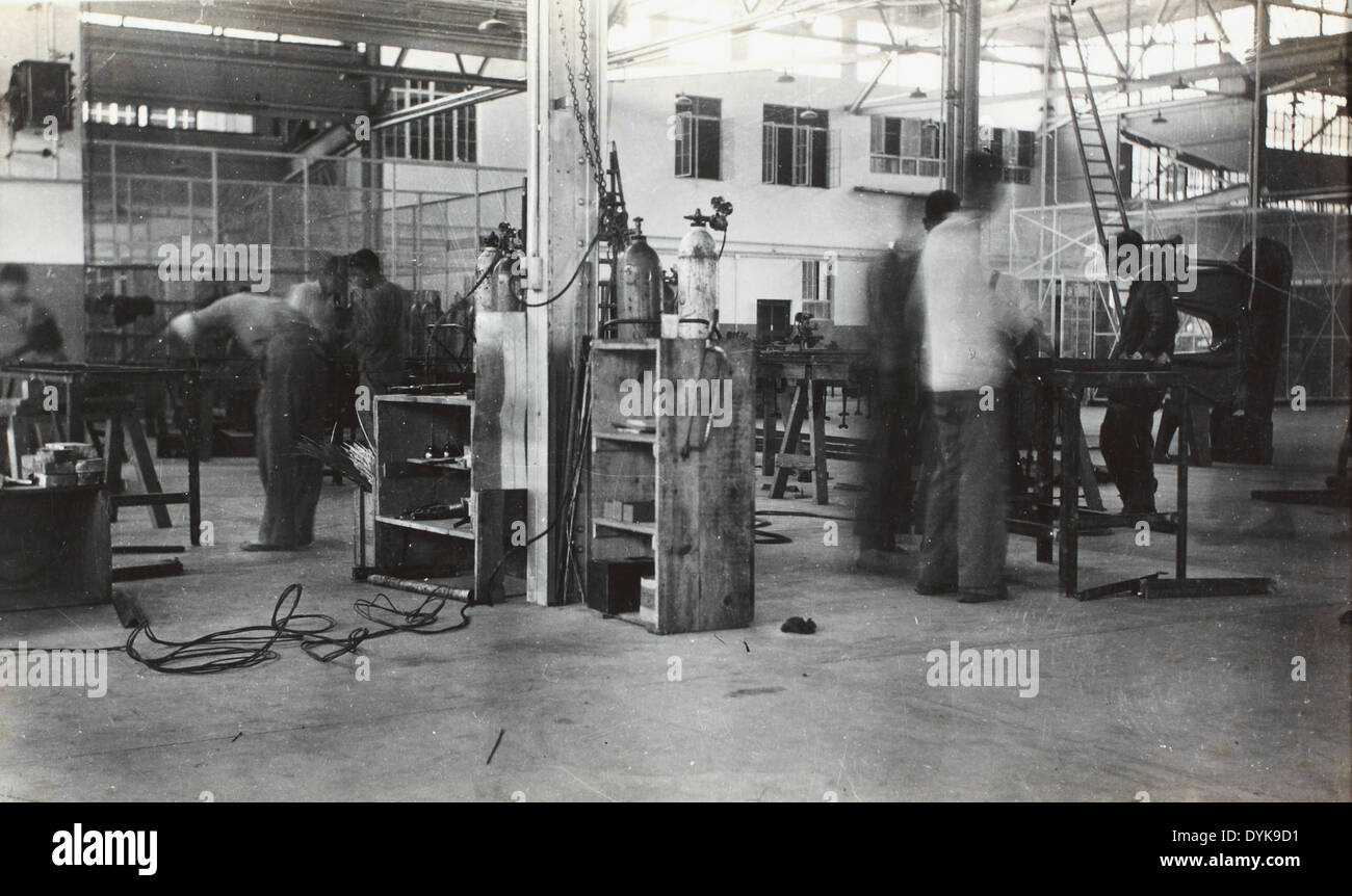 This photo captures workers in an aircraft manufacturing factory during ...
