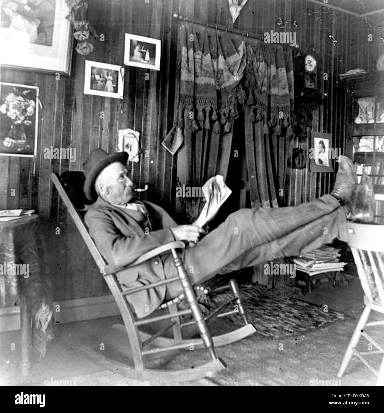 This image shows an older man in a living room in St. Andrews, Florida ...