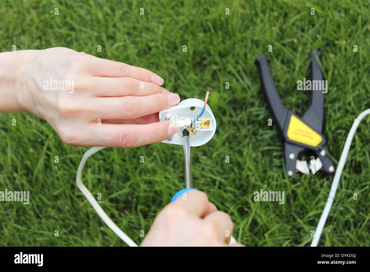 Hand of an electrician installing a power plug Stock Photo - Alamy