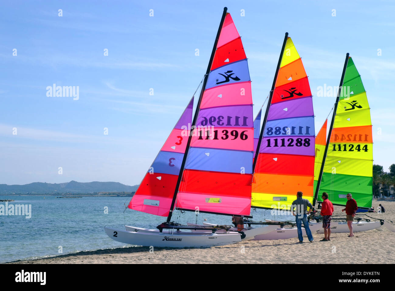 colorful sails on the beach in Pollensa , Isle of Mallorca, Spain Stock ...