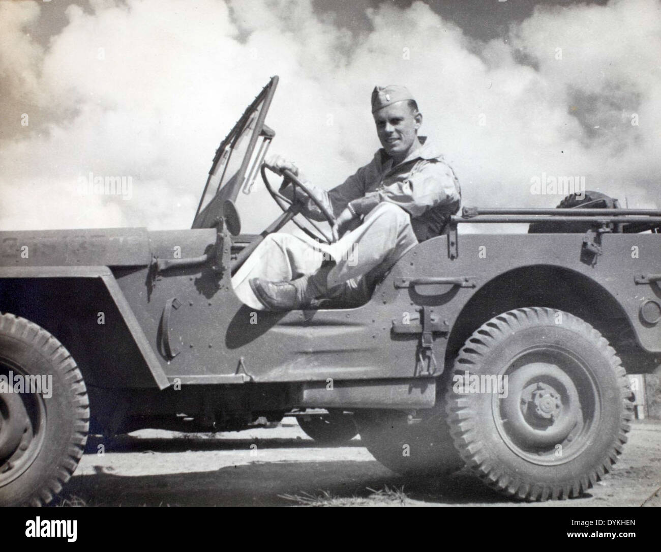 This photograph depicts a lieutenant driving a jeep, likely in a ...