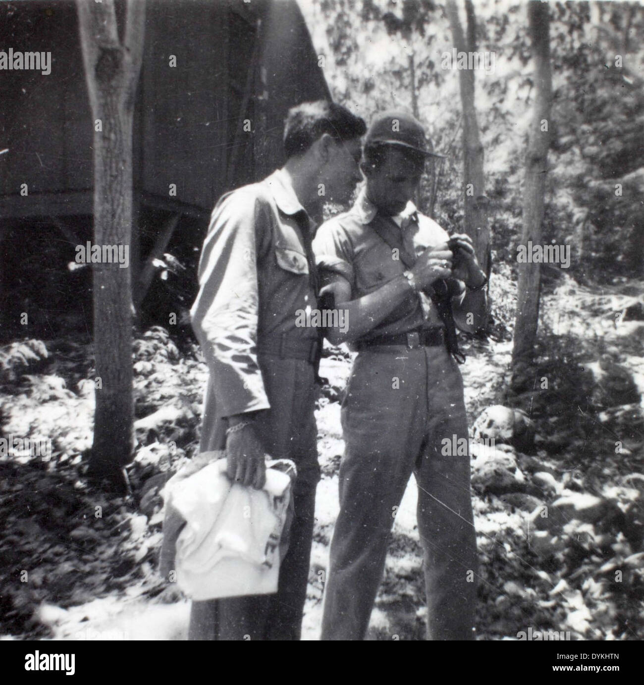 This image captures a group of men engaged in conversation, with no ...
