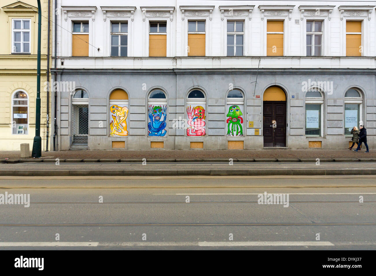 Modern graffiti in the windows of old houses in Prague. Prague is the ...