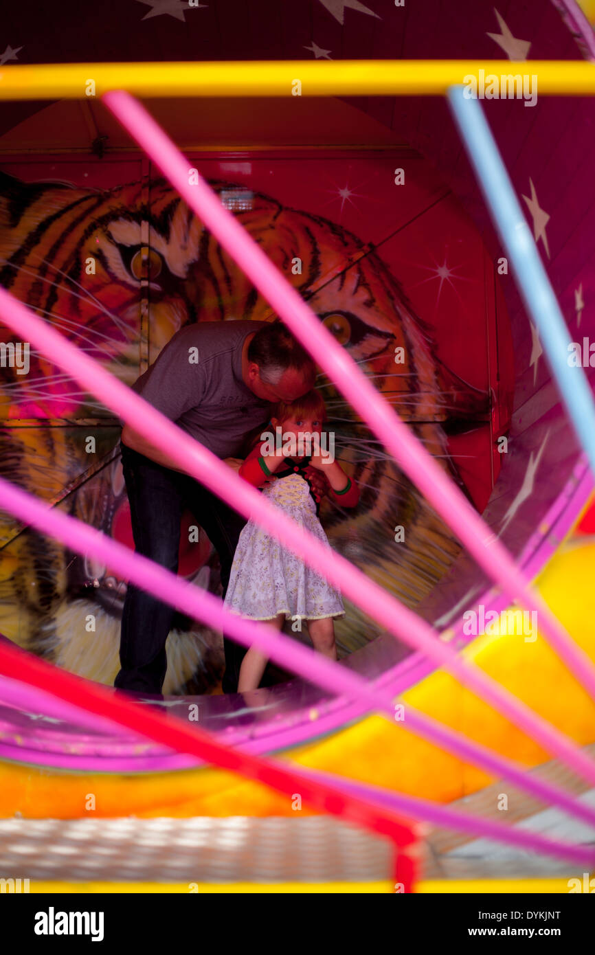 Child on colorful fair attraction having fun Stock Photo - Alamy