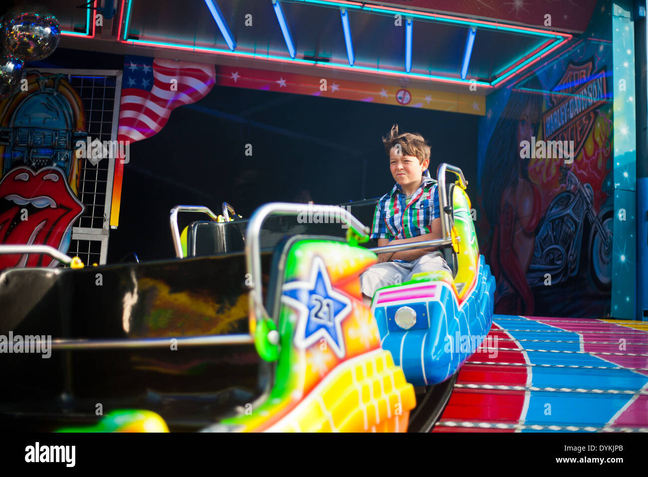 Child on colorful fair attraction having fun Stock Photo - Alamy