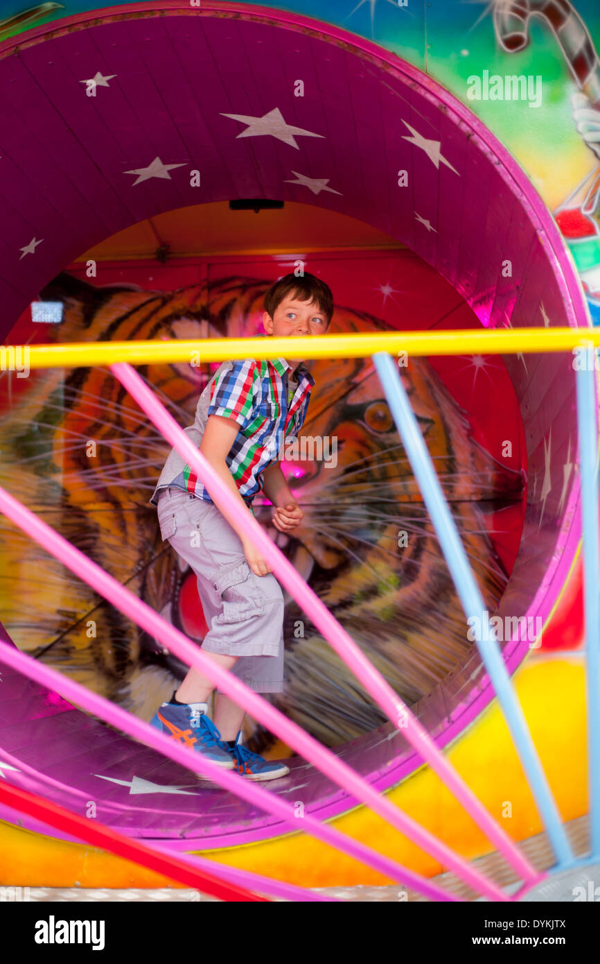 Child on colorful fair attraction having fun Stock Photo - Alamy