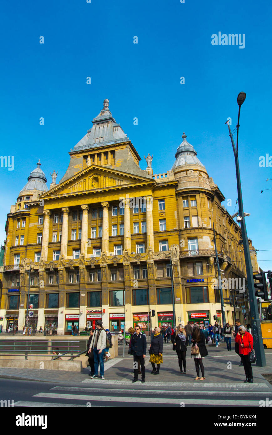 People crossing the street in front of Anker palace, Deak Ferenc ter ...
