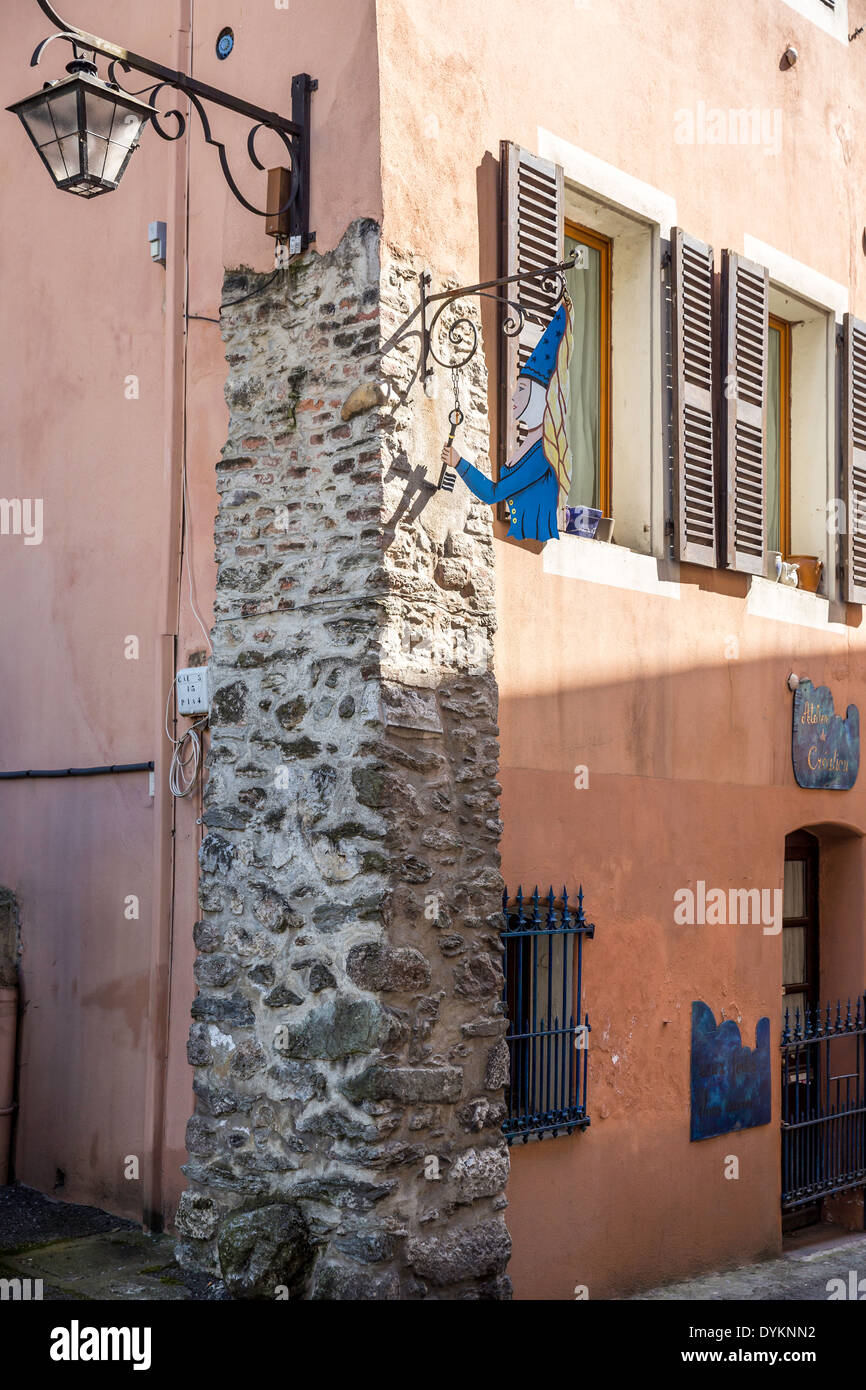 The stone corner of a building with a metal and glass street lamp and a ...