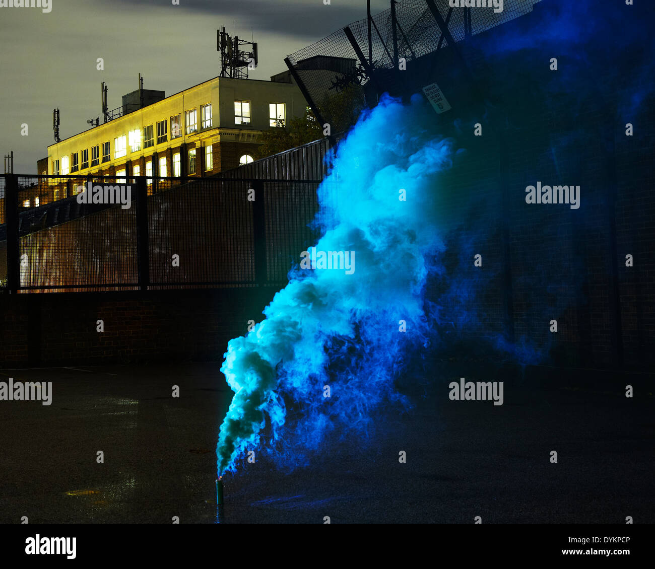 Blue smoke canister being set of in London Stock Photo - Alamy