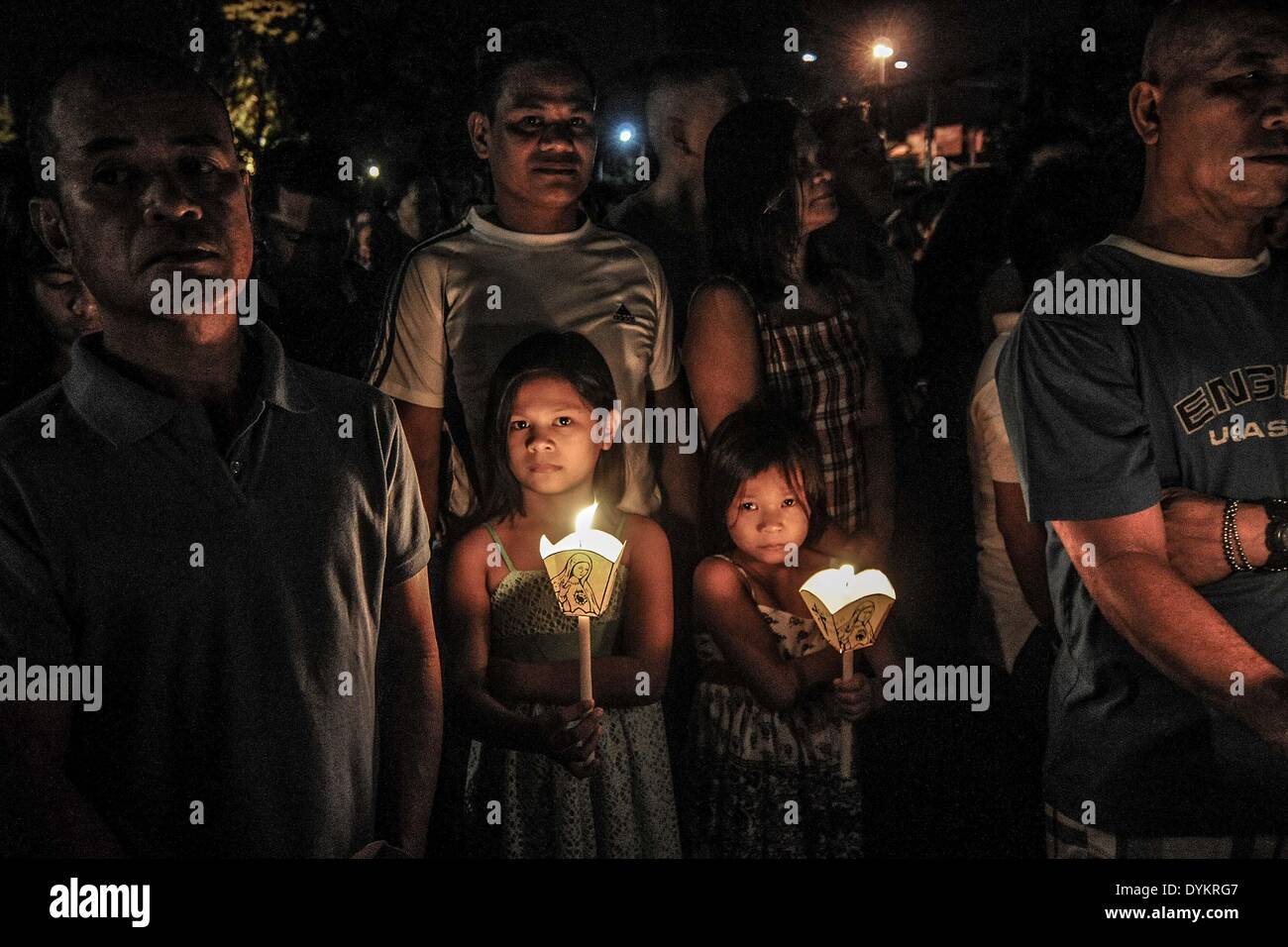 Quezon, Philippines. 20th Apr, 2014. Filipino Catholics light candles ...