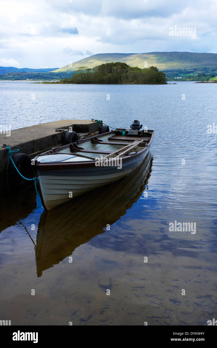 A boat tied to a dock on an Irish lake Stock Photo - Alamy
