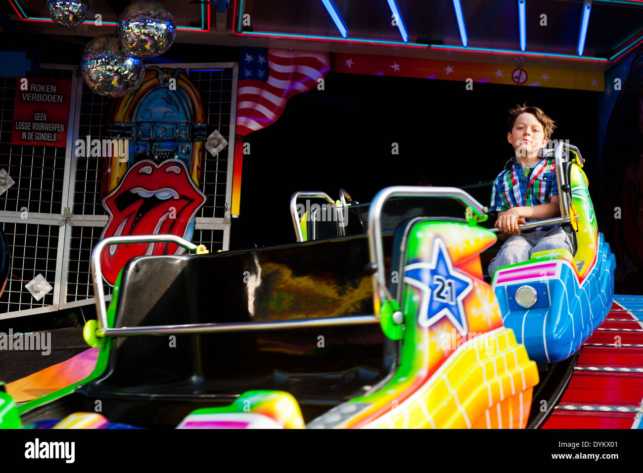Child on colorful fair attraction having fun Stock Photo - Alamy