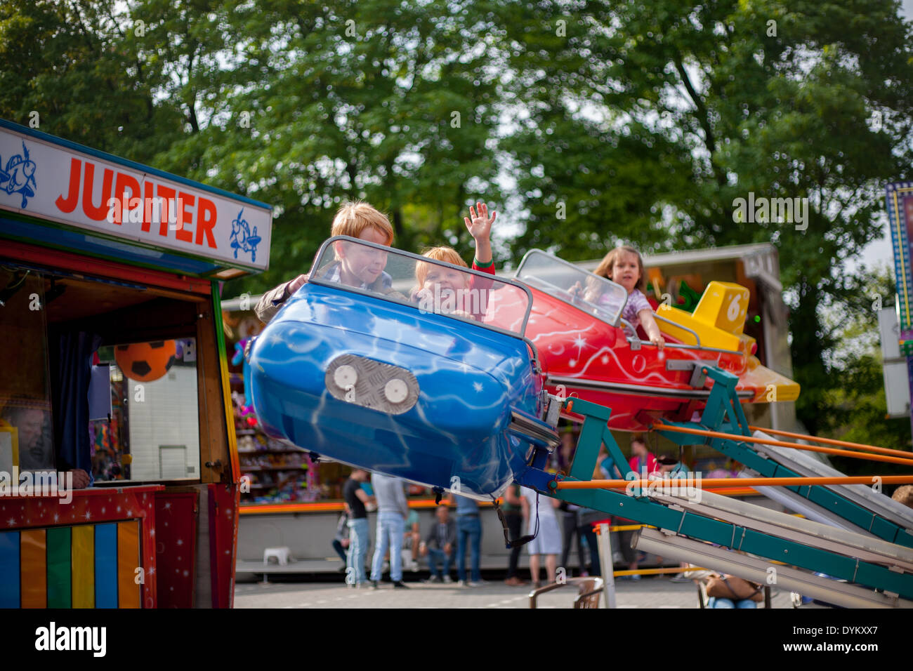 Child on colorful fair attraction having fun Stock Photo - Alamy