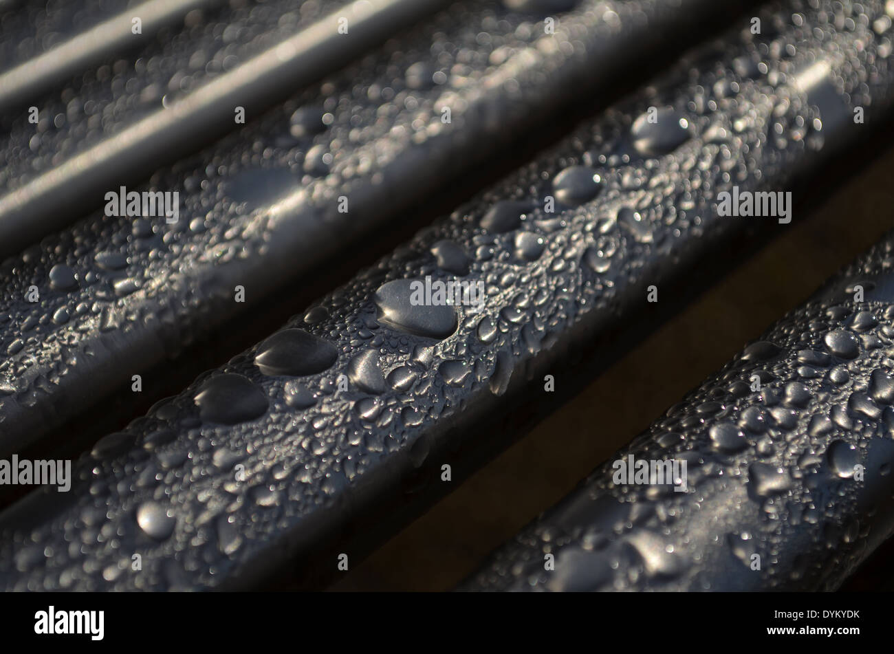 Closeup of rain droplets on steel seat rods Stock Photo - Alamy