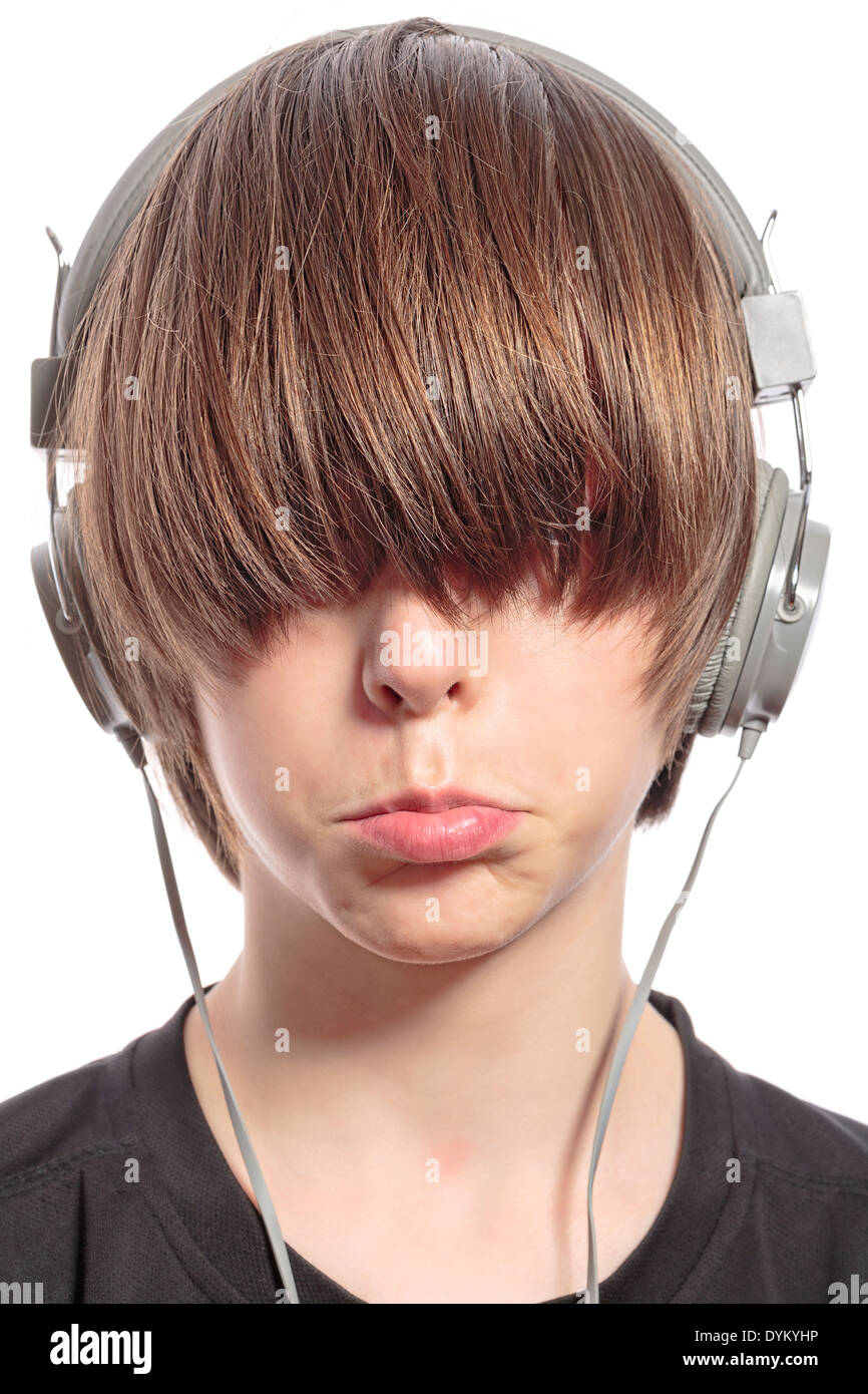 sulking cute teenager boy with hair over his eyes and headphones Stock ...