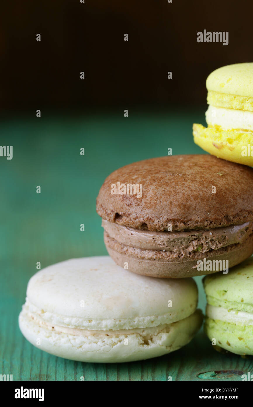French multicolored macaroons cookies on a vintage wooden background ...
