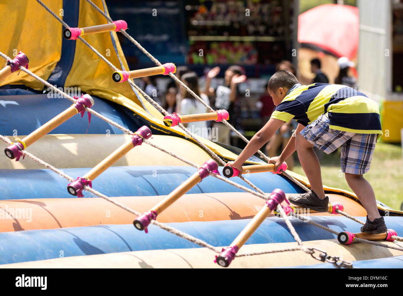 A young boy climbing a ladder Stock Photo - Alamy