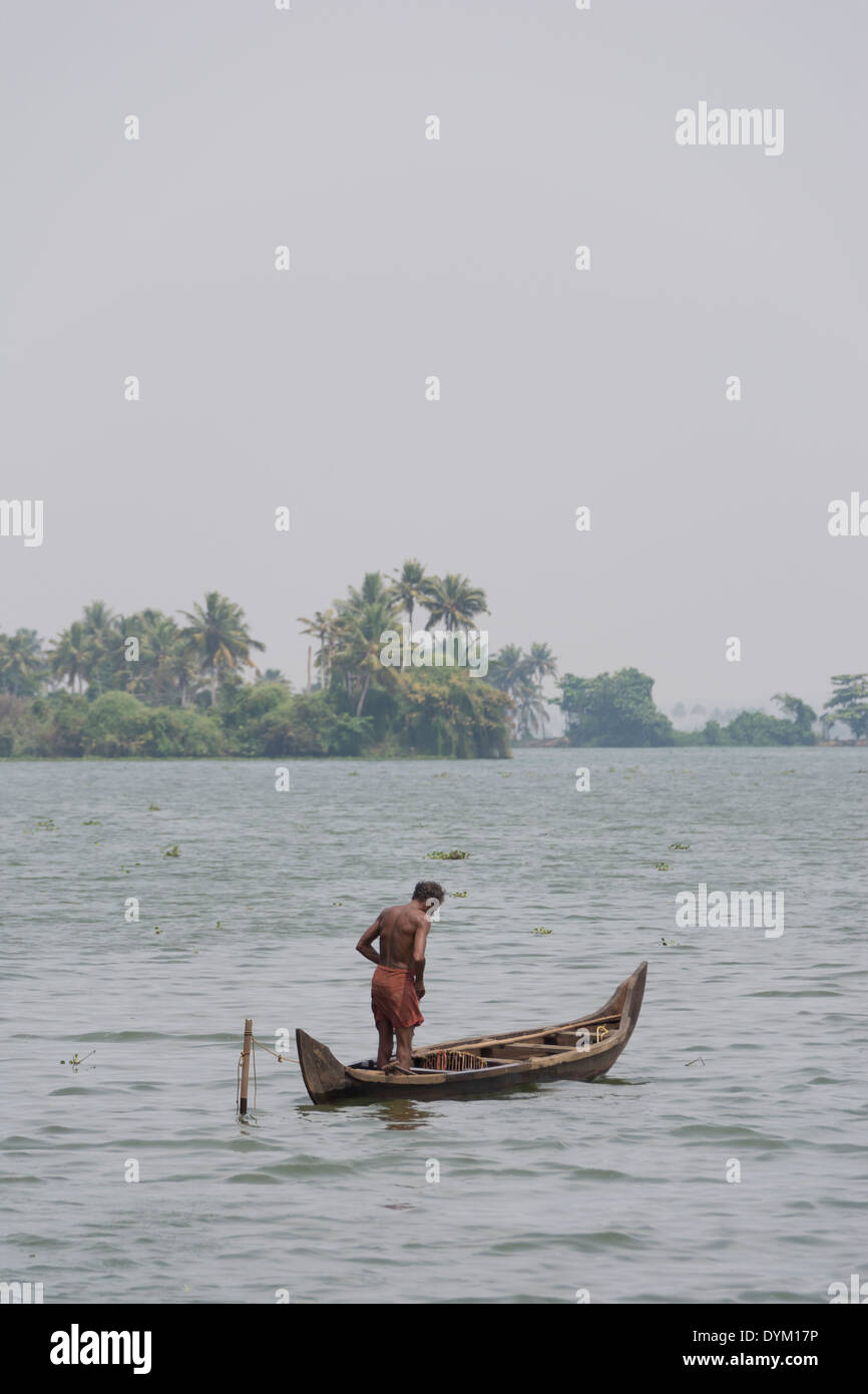 A fisherman working at the harvesting of shellfish in the backwaters of ...