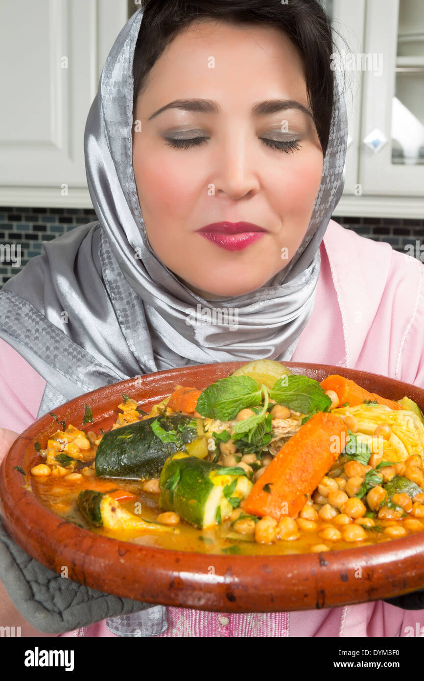 Moroccan immigrant woman in Europe presenting her tajine dish during ...