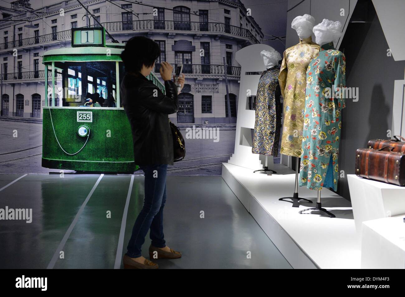 Shanghai, China. 22nd Apr, 2014. A visitor takes photos of cheongsams ...