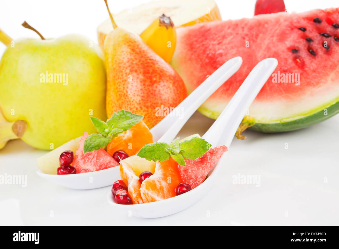 Delicious fruits pieces on white spoon. Healthy summer fruit background ...