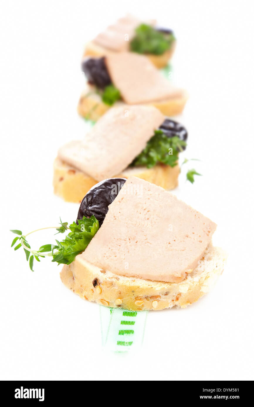 Luxurious culinary eating. White bread with pate, herbs and dried plumb ...