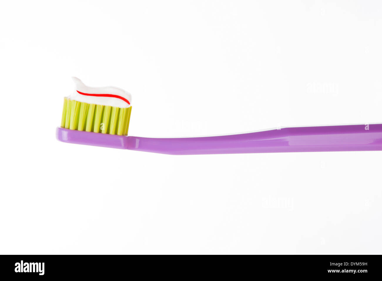Purple toothbrush with striped red and white toothpaste isolated on ...