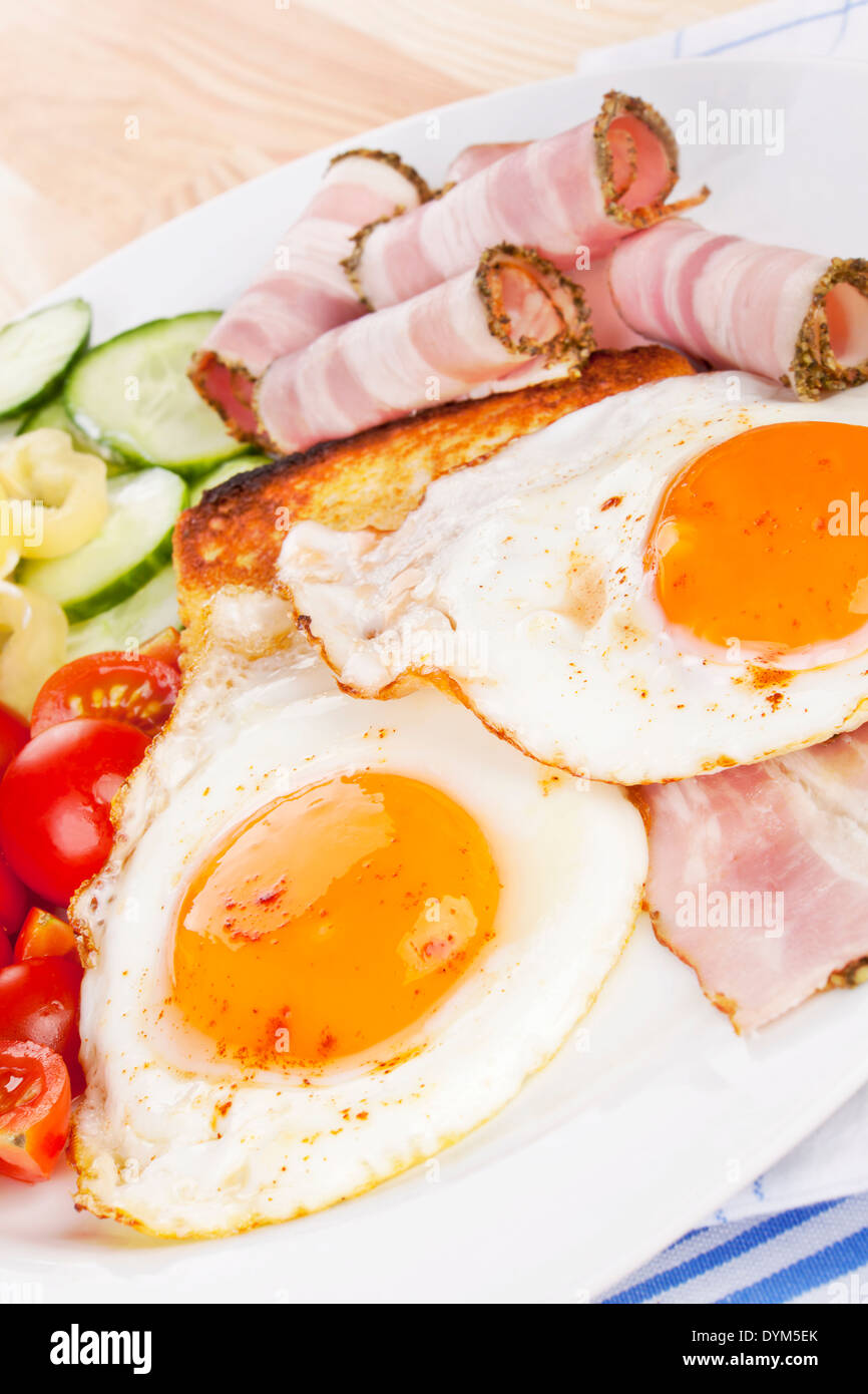 Traditional western breakfast. Fried eggs, ham, toast and fresh ...