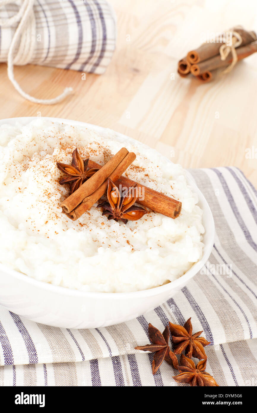 Culinary rice pudding with cinnamon and star anise garnish in white ...