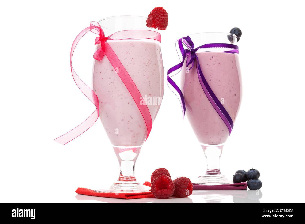 Raspberry and blueberry milkshake isolated on white background. Healthy ...