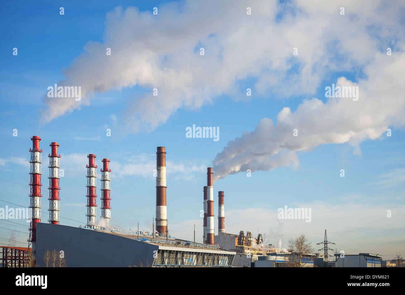 Industrial landscape. Power plant tubes with smoke above blue sky Stock ...