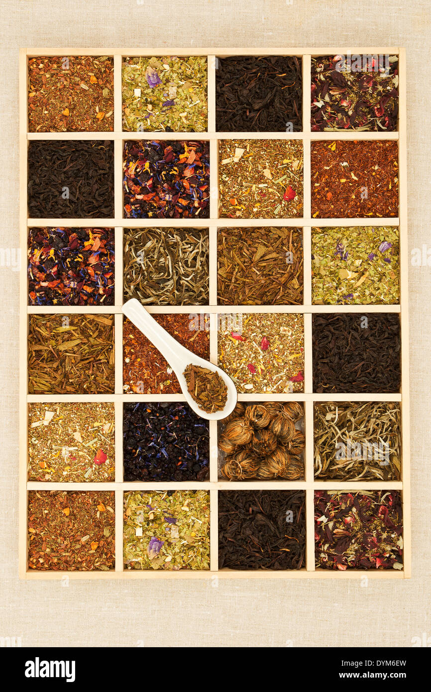 Different tea sorts in wooden box. Dry tea leaf collection. Top view ...