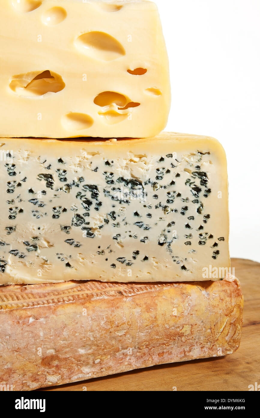 Three various big cheese pieces arranged on each other. Cheese ...