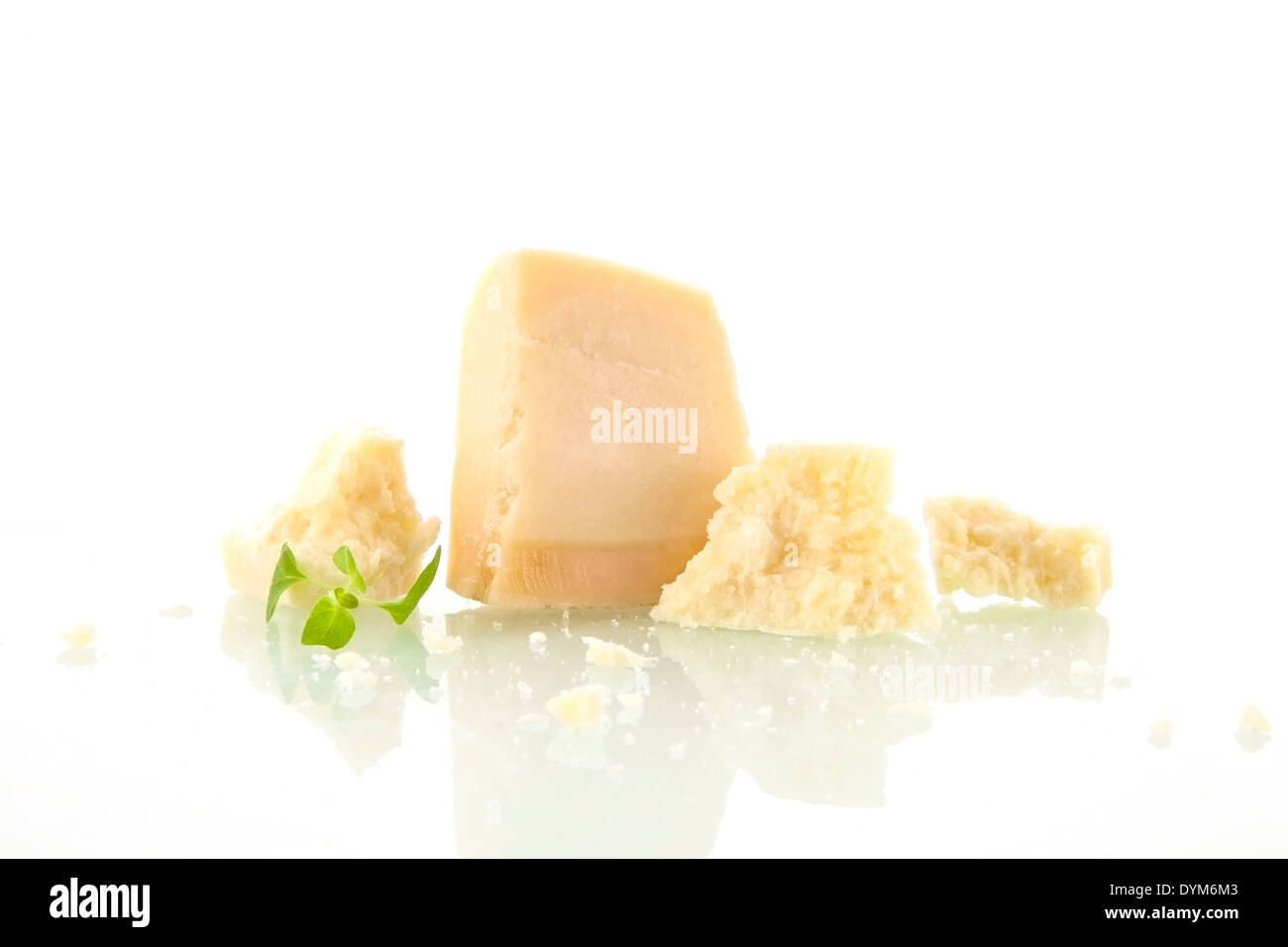 Parmesan pieces isolated on white background with basil leaves. Cheese ...