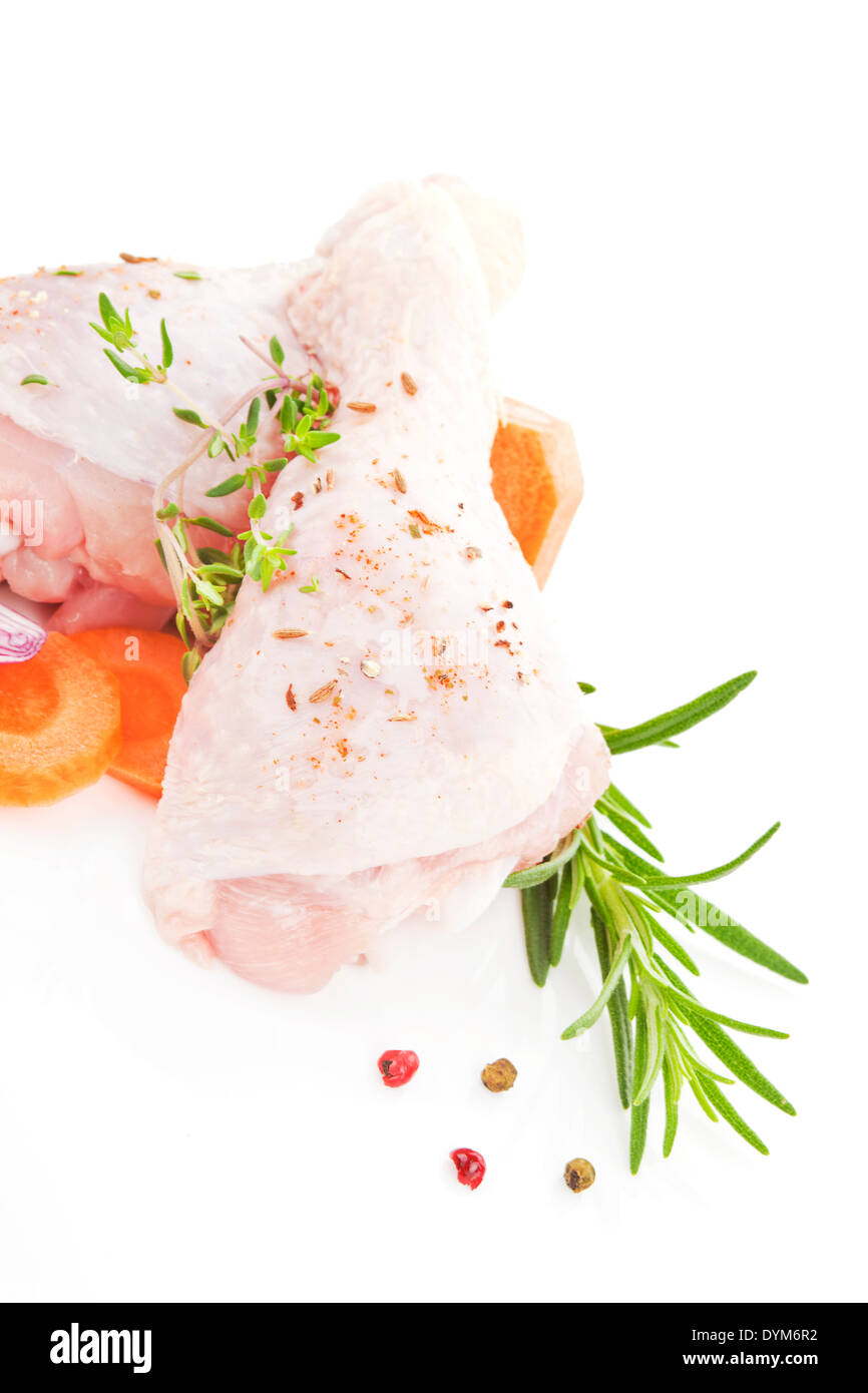 Two chicken legs with fresh vegetables isolated on white background ...